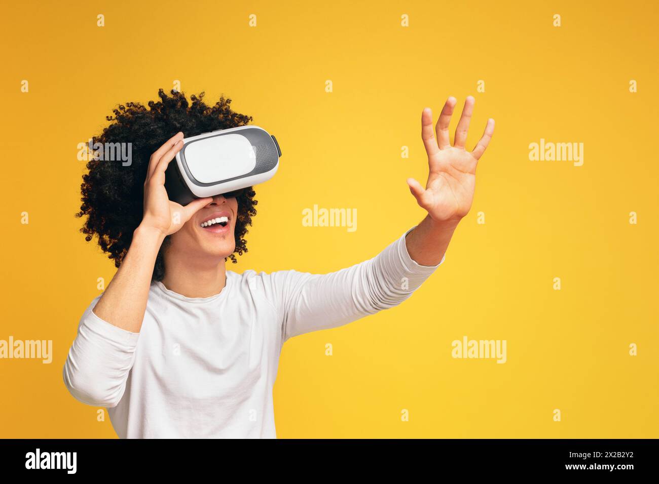 Excited black guy pushing virtual button in VR glasses Stock Photo - Alamy