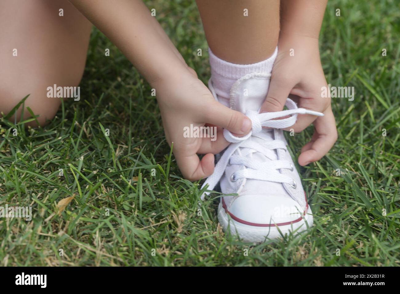 Kid tying shoes. Little girl struggling to tie shoe laces. Child ...