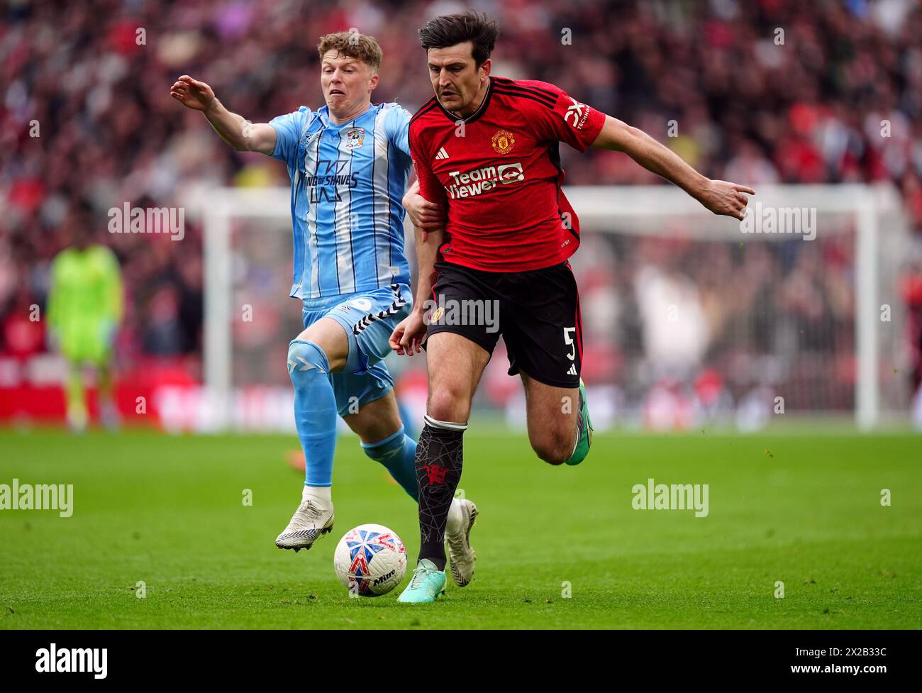 Manchester United's Harry Maguire and Coventry City's Victor Torp (left ...