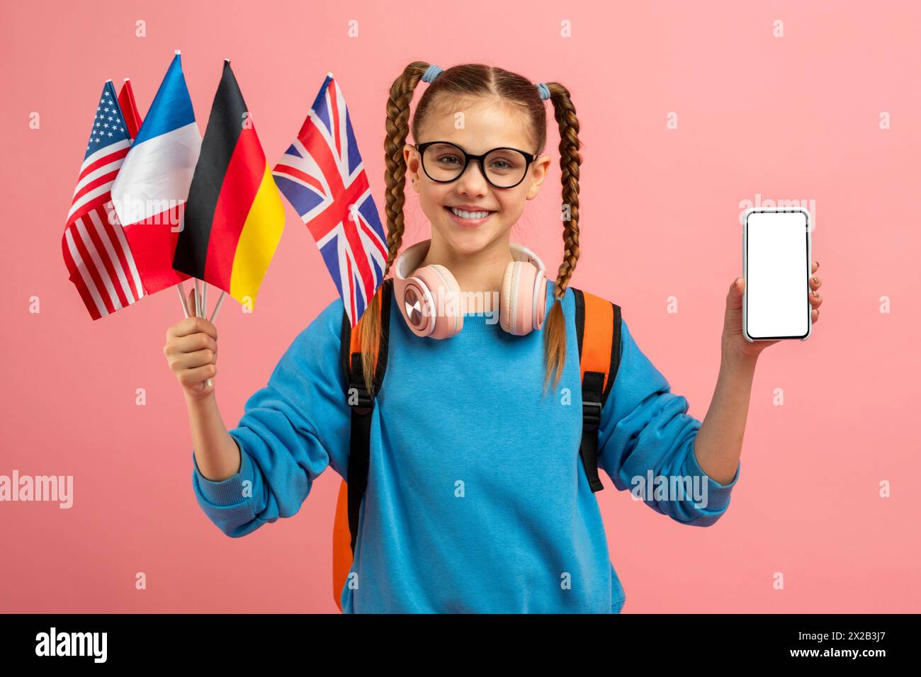 Youth holding flags and showing phone screen Stock Photo - Alamy