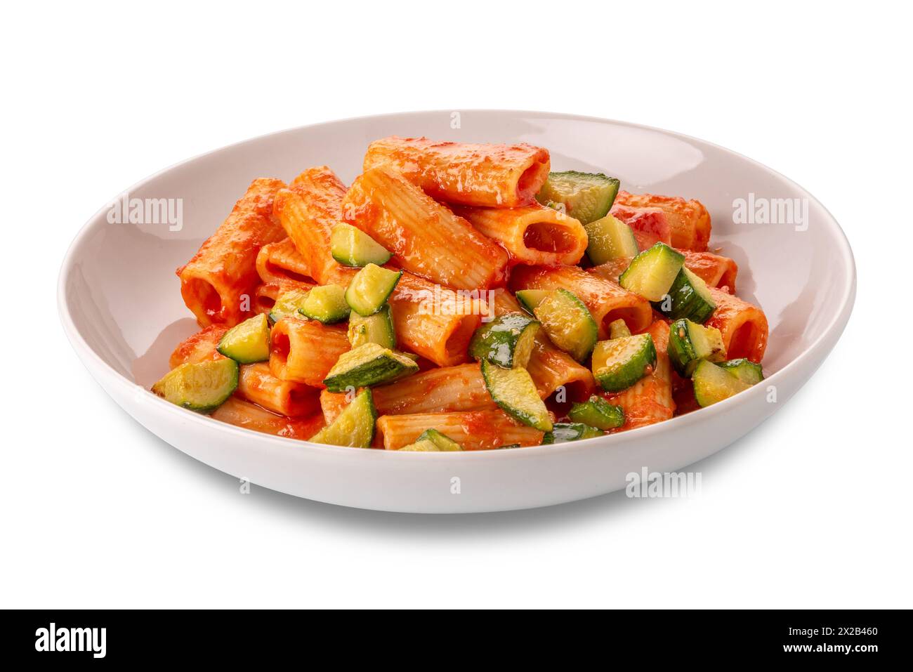 Rigatoni macaroni pasta with tomato sauce and zucchini in a white plate ...