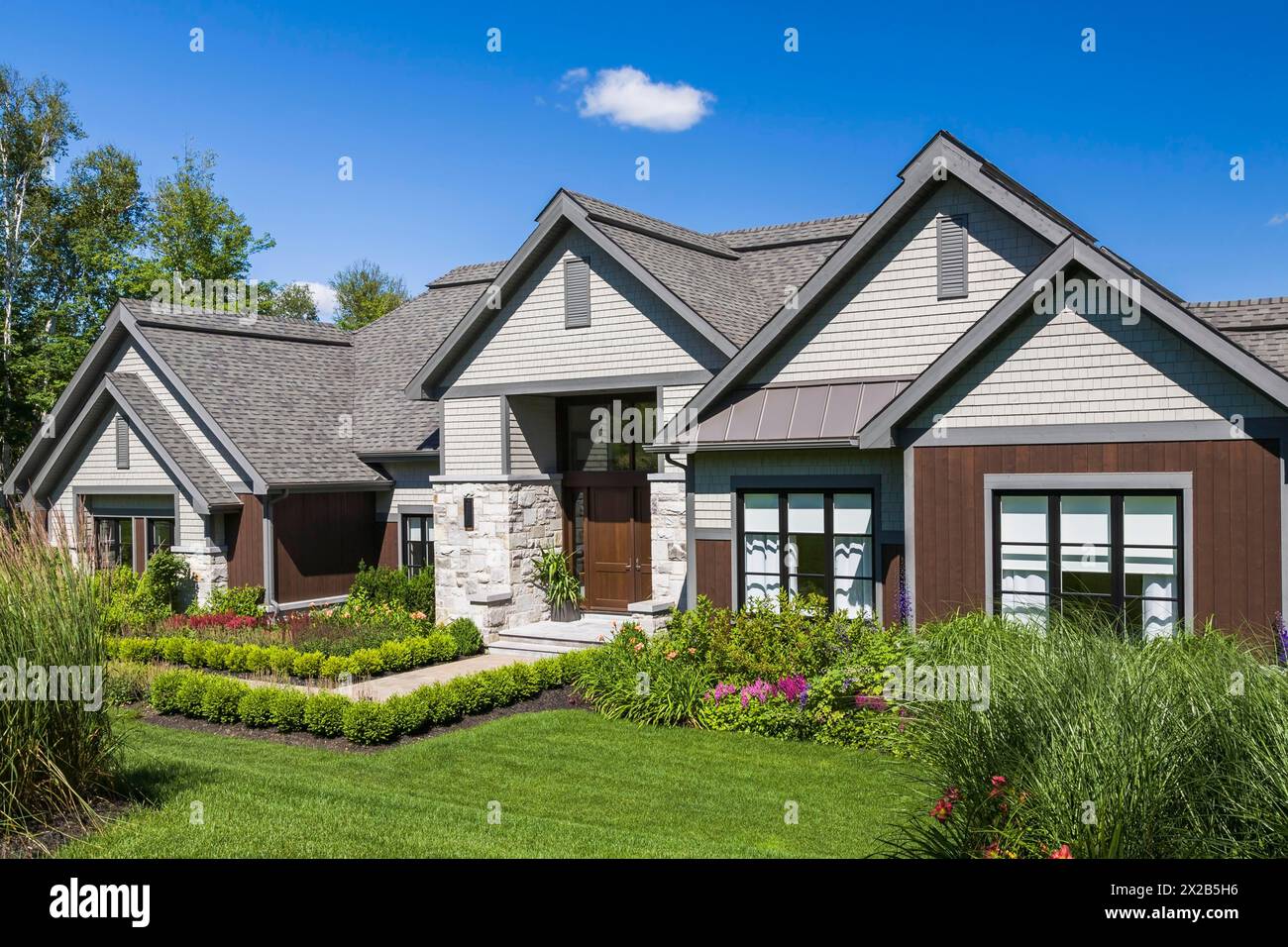 Contemporary natural stone and brown stained wood and cedar shingles ...