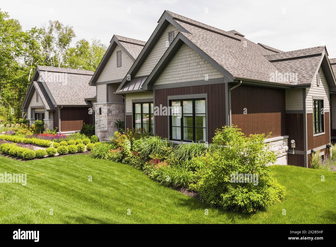 Contemporary natural stone and brown stained wood and cedar shingles ...