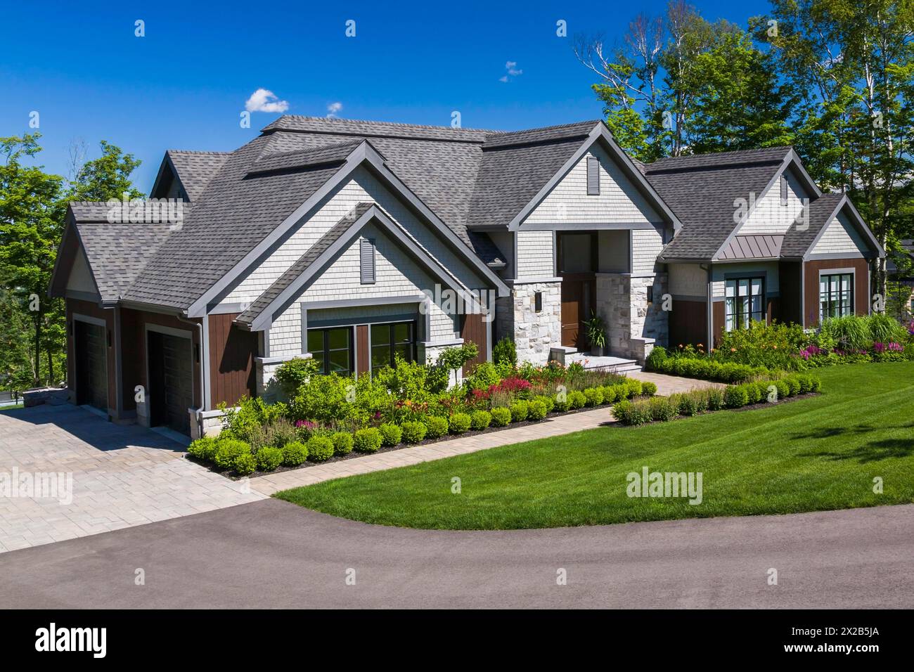 Contemporary natural stone and brown stained wood and cedar shingles ...