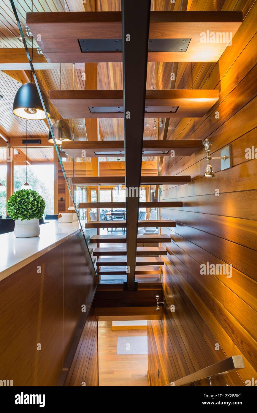 Underside view of illuminated wooden staircase with opened steps and ...