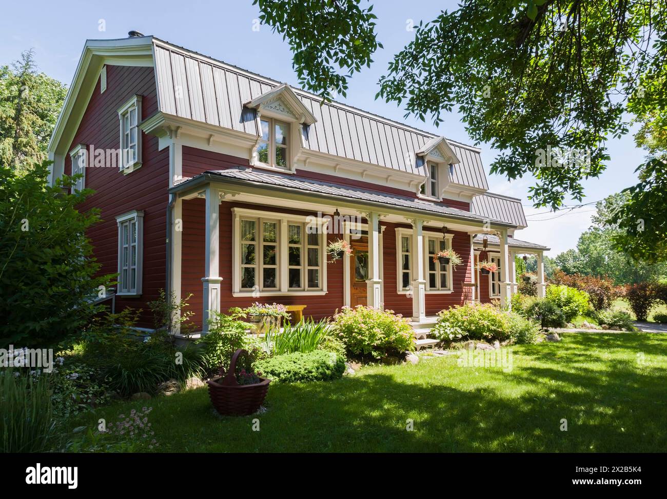 Old 1892 burgundy with white trim pinewood plank house facade with ...