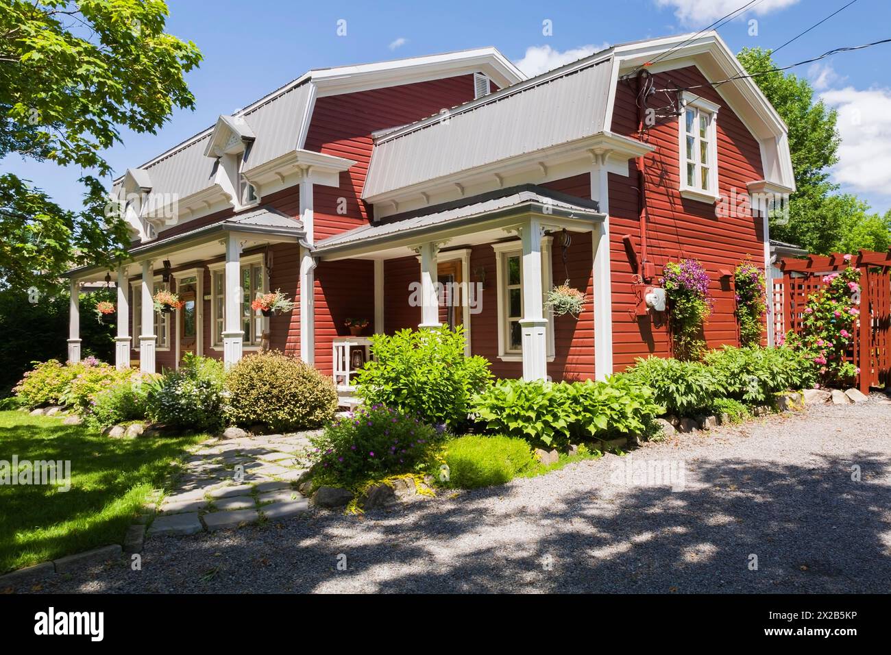 Old 1892 burgundy with white trim pinewood plank house facade with ...