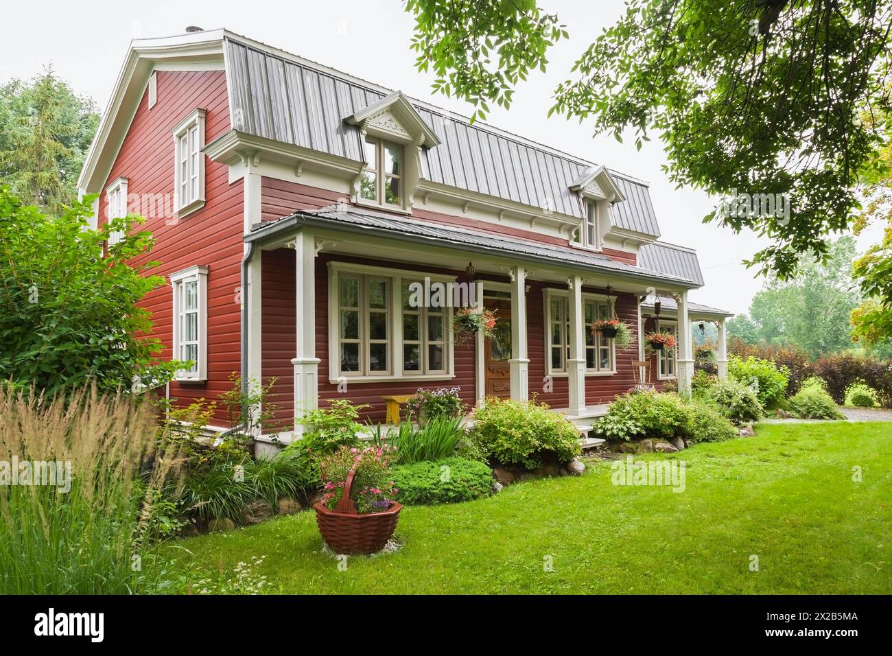 Old 1892 burgundy with white trim pinewood plank house facade with ...