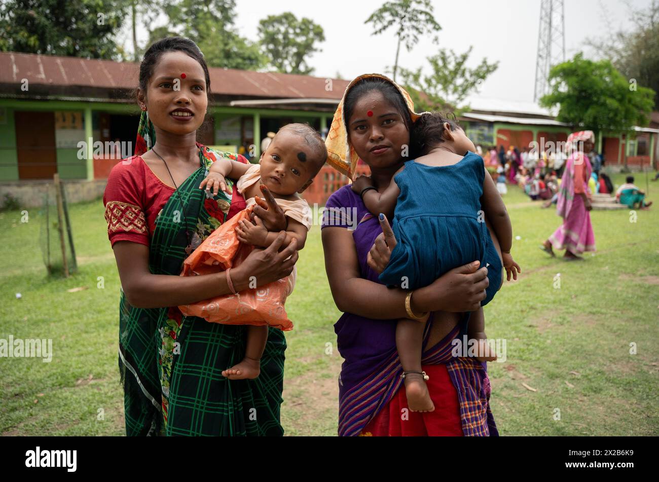 BOKAKHAT, INDIA, APRIL 19: Women with child show their marked finger ...