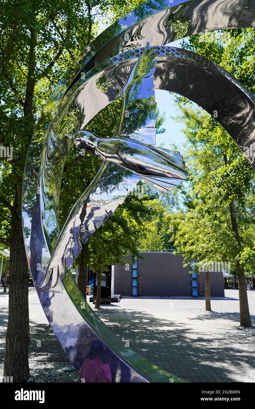 Beijing, China, Asia, Abstract shiny metal sculpture reflects the ...
