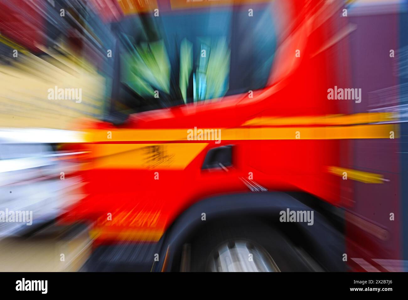Focussed on the tyre, the image shows a fast-moving fire engine Stock ...