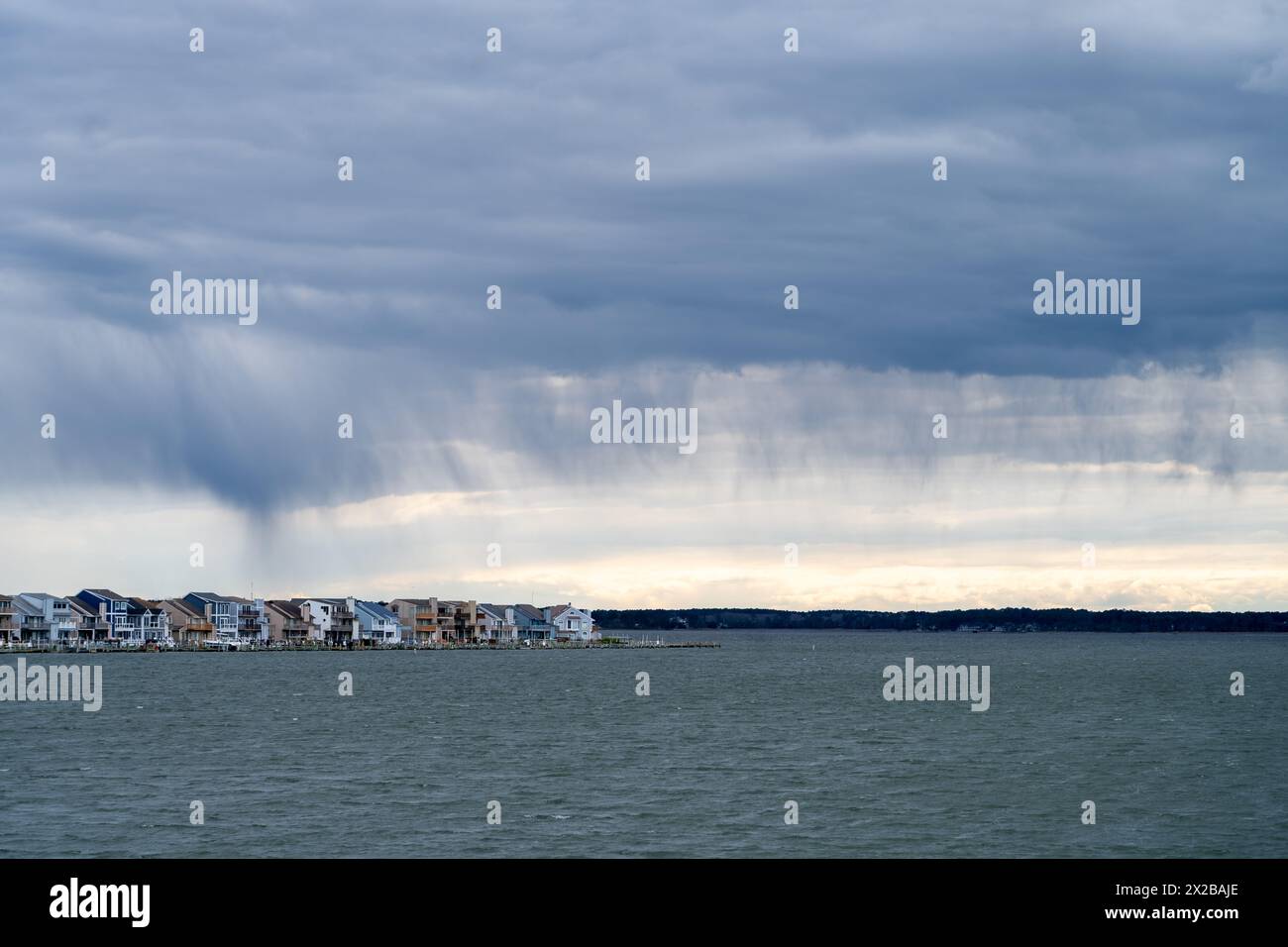 Distant rain storm over waterfront homes in Ocean City, Maryland. Rain ...
