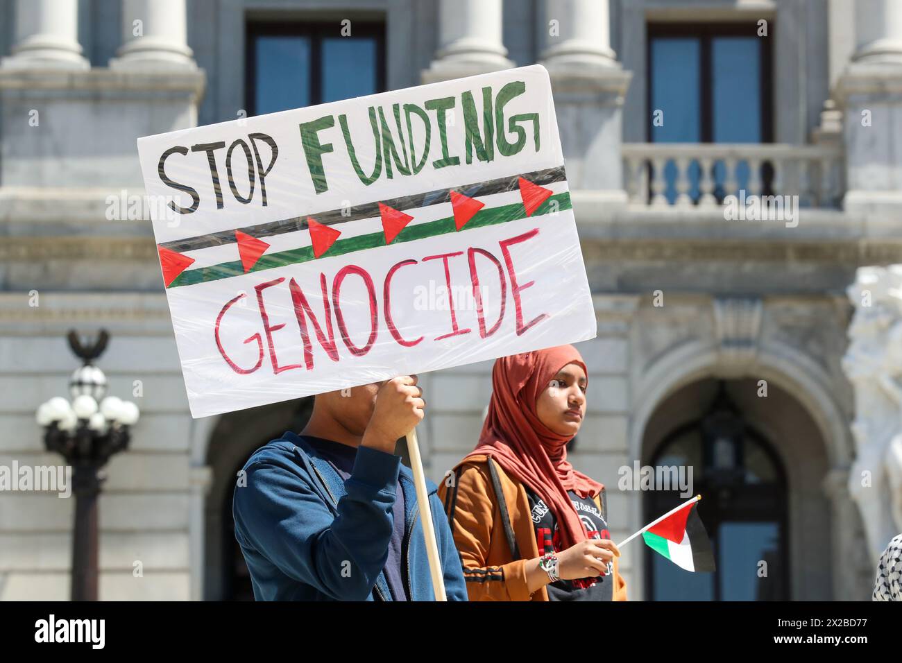 Harrisburg, Pennsylvania, USA. 20th Apr, 2024. A protester holds a ...