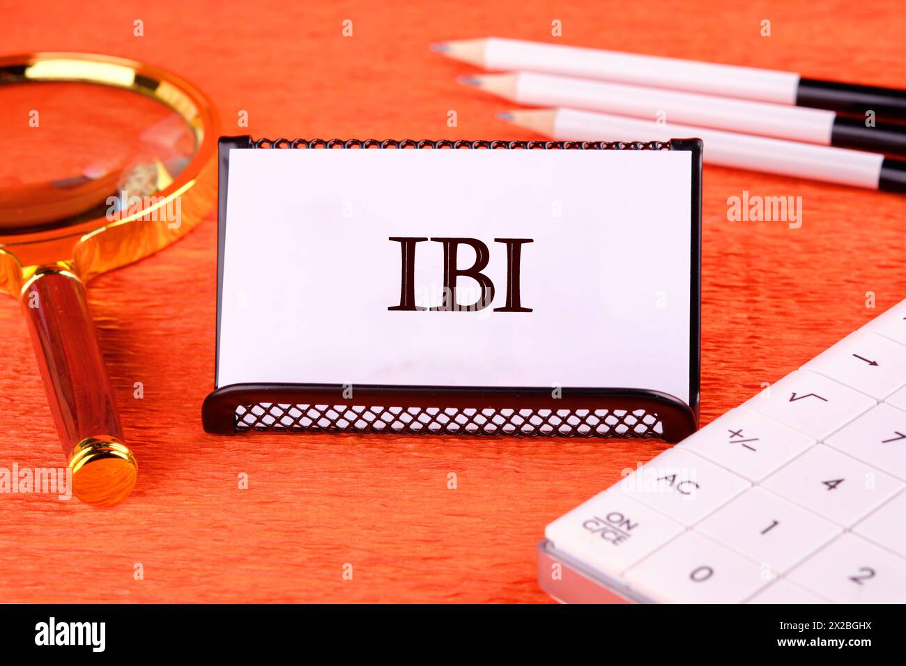IBI symbol there is a magnifying glass, a calculator, and pencils on a ...