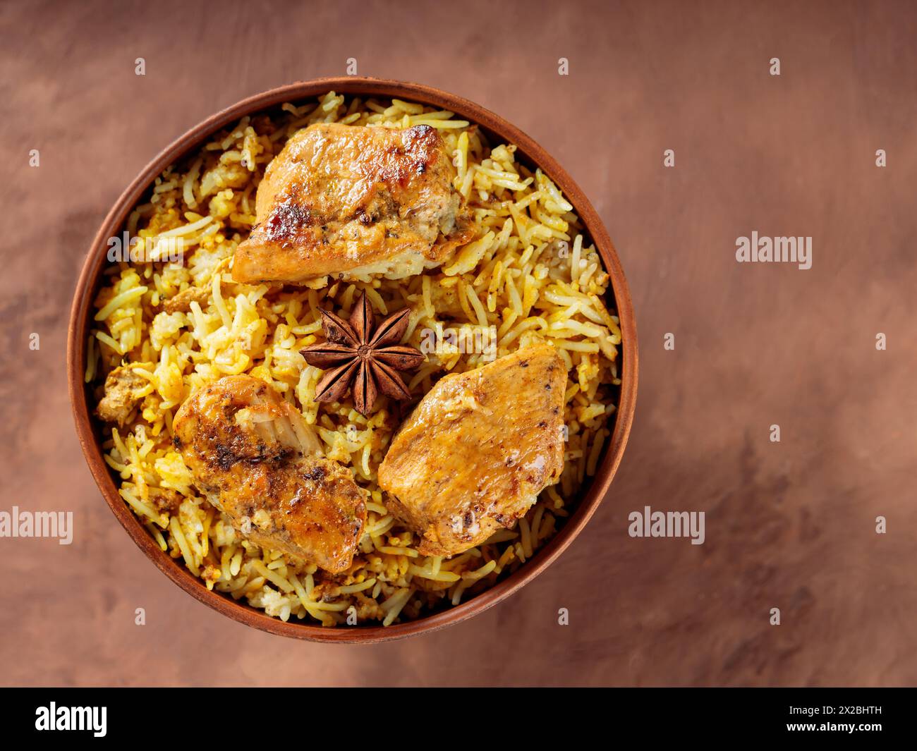 Chicken Biryani with Basmati Rice, Spices and Lemon on Brown Background ...