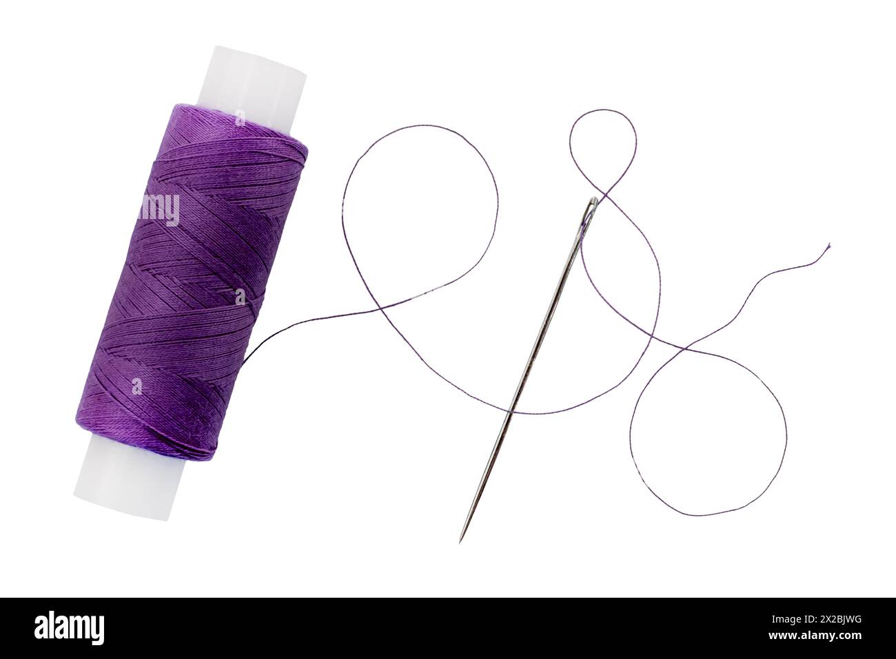 Old spool of thread and needle on a white background. Sewing ...