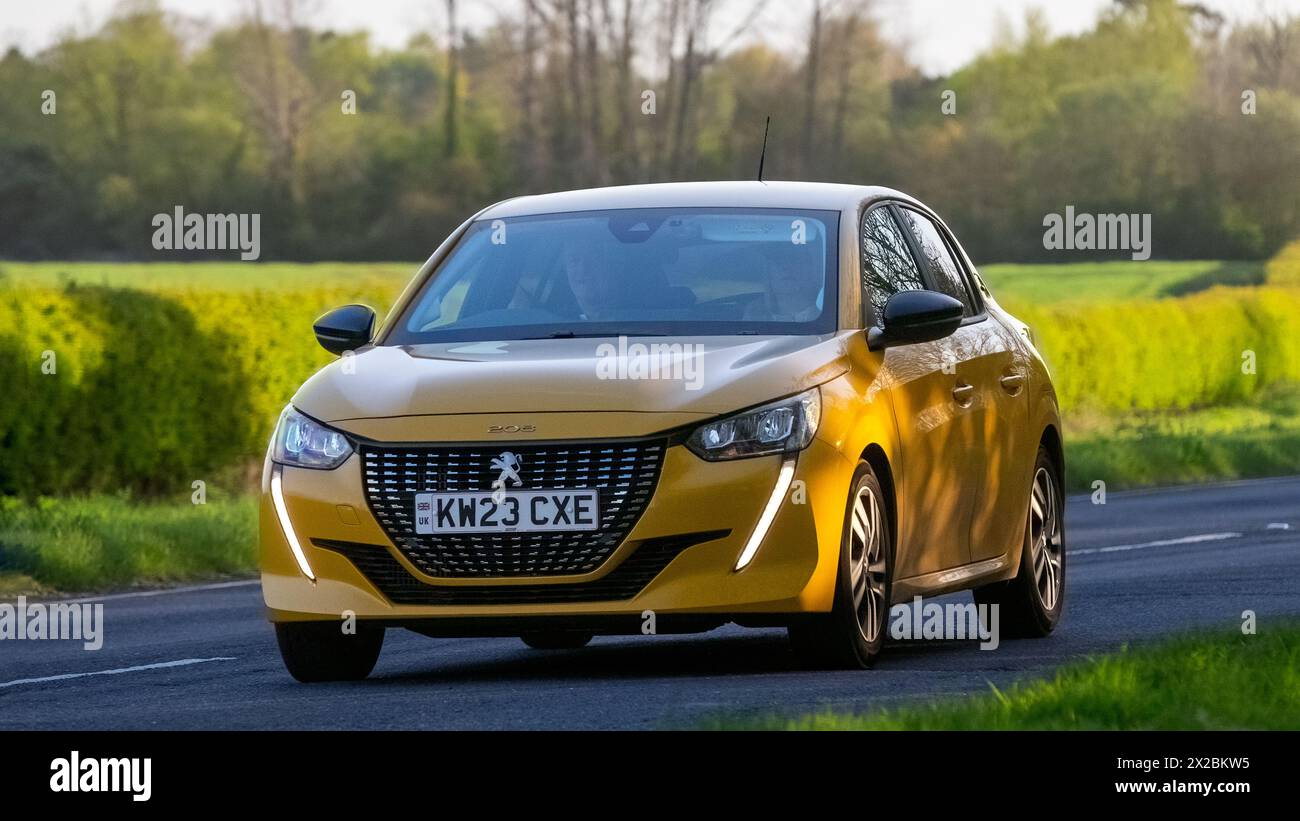 Bicester,UK- Apr 21st2024: 2023 yellow Peugeot 208 classic car driving ...