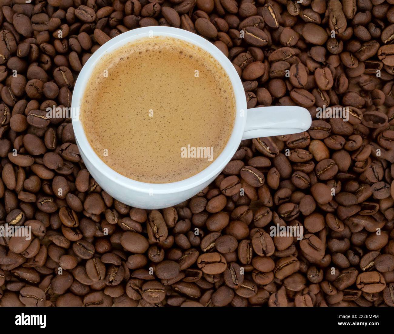 Coffee cup and coffee beans. Fresh roasted coffee bean background with ...