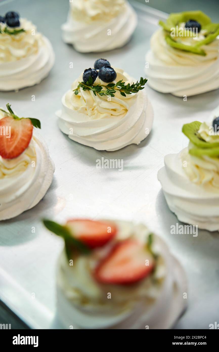 Crispy and tasty meringue nests with fruit curd inside Stock Photo - Alamy