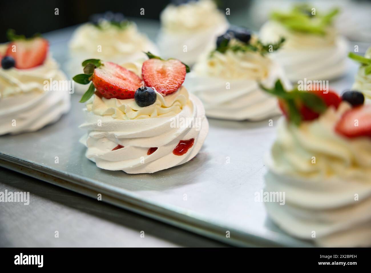 Crispy and airy meringue nests filled with fruit mousse Stock Photo - Alamy