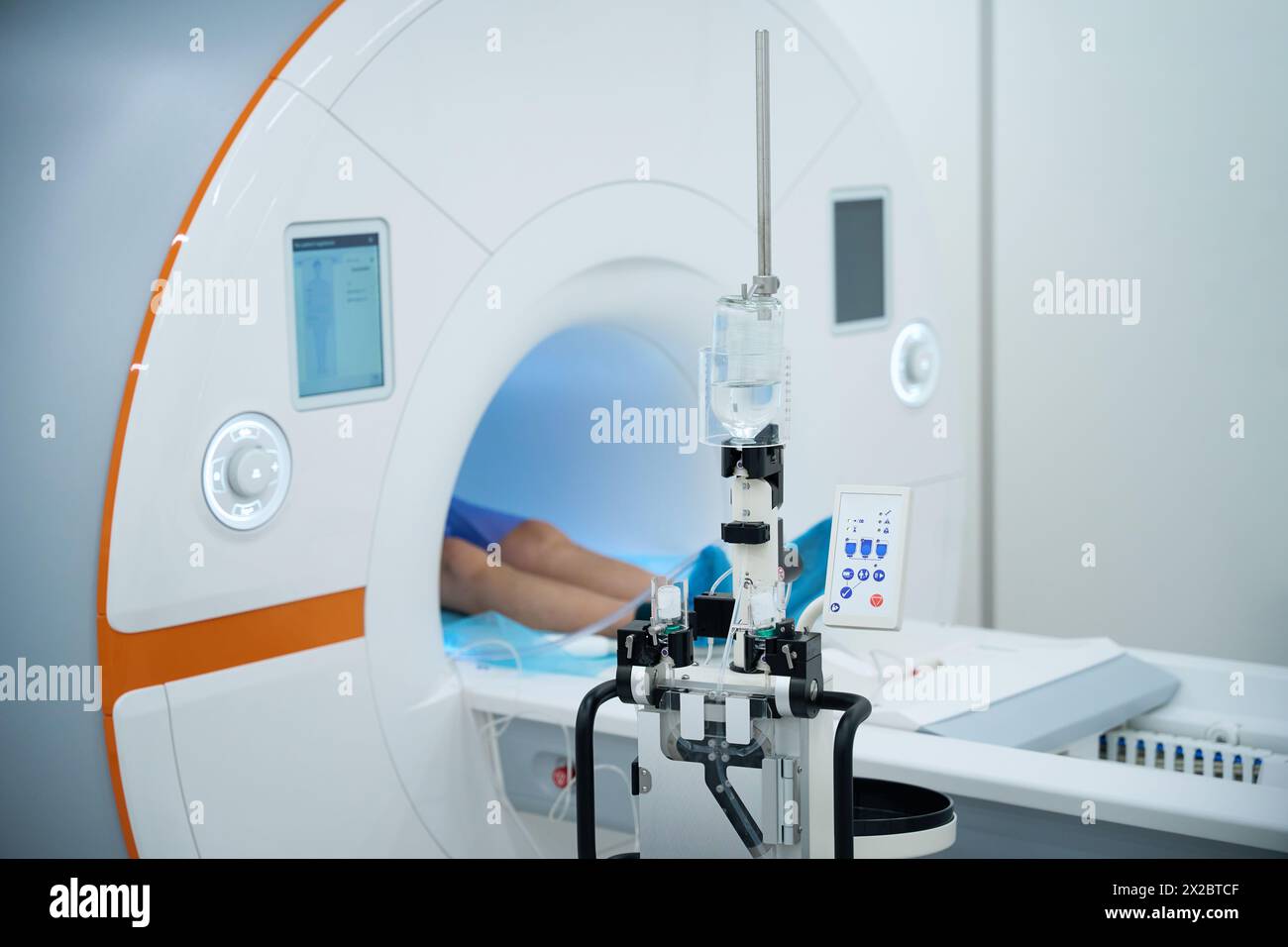 Clinic client undergoing contrast-enhanced magnetic resonance imaging ...