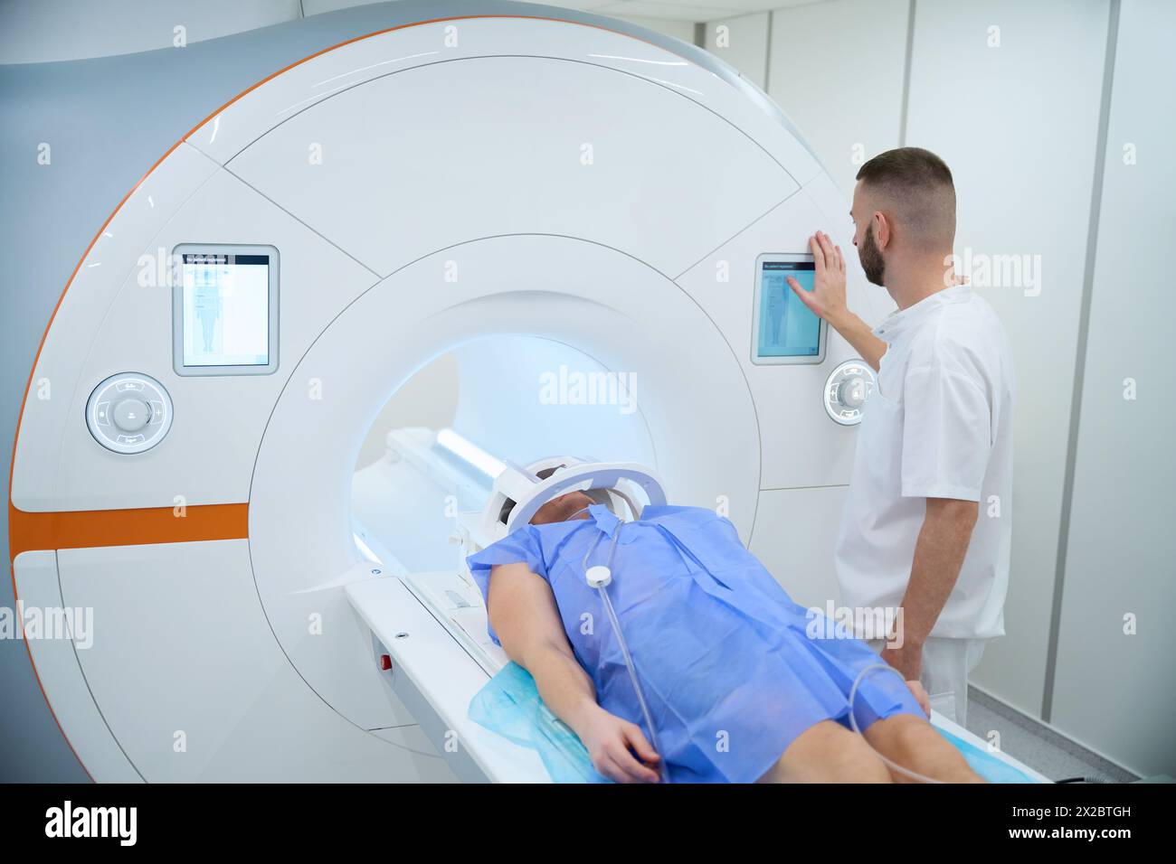 Radiographer positioning adult patient for brain MRI Stock Photo - Alamy