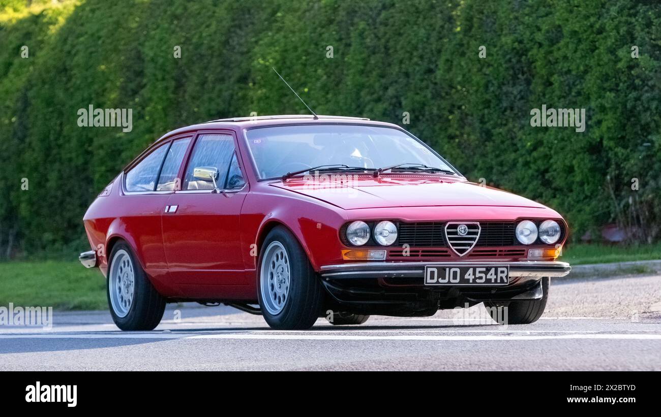 Bicester,UK- Apr 21st2024: 1976 red Alfa Romeo classic car driving on a ...