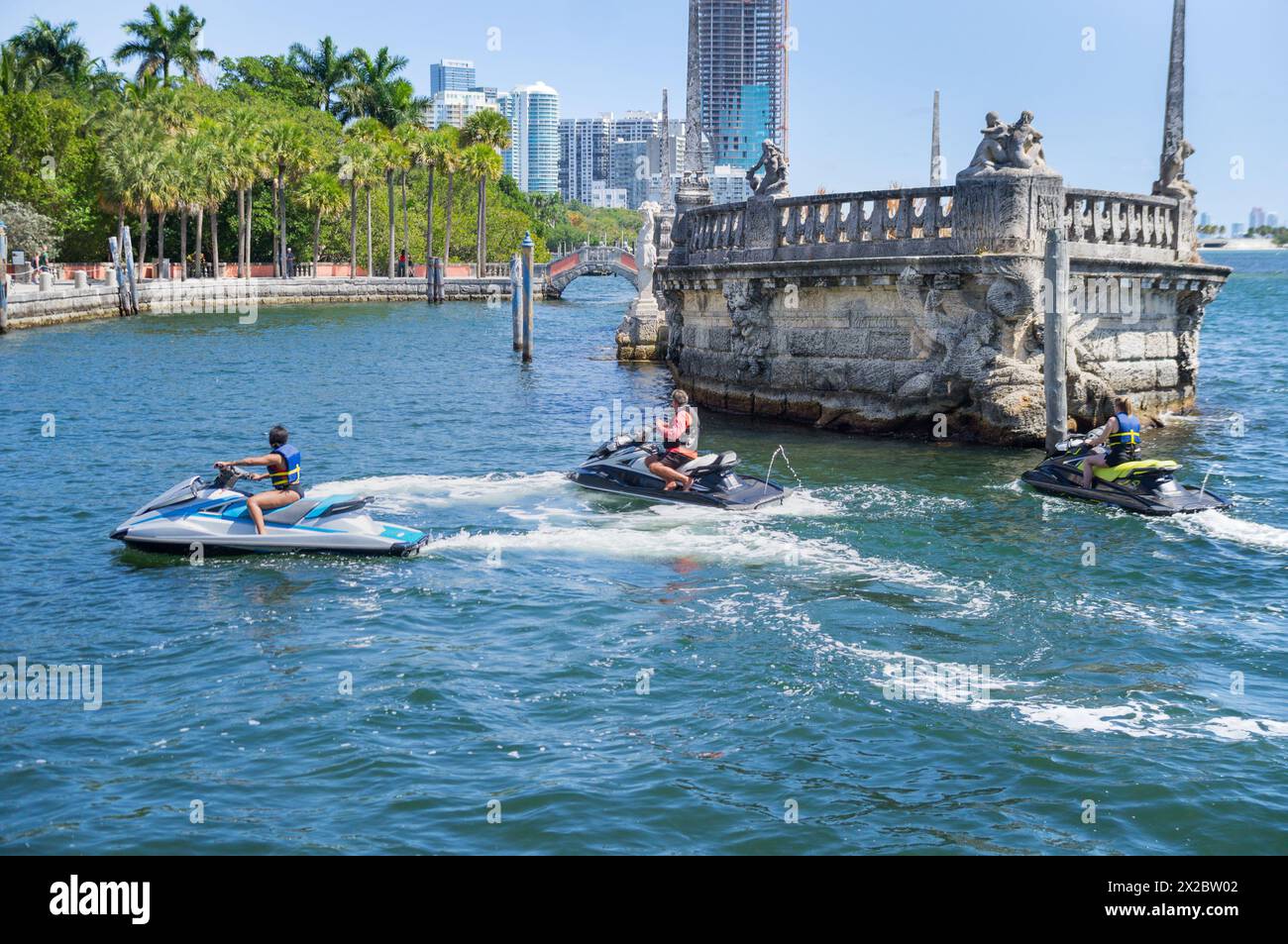 Tourists riding jet ski boats in turquoise waters of Biscayne Bay in ...