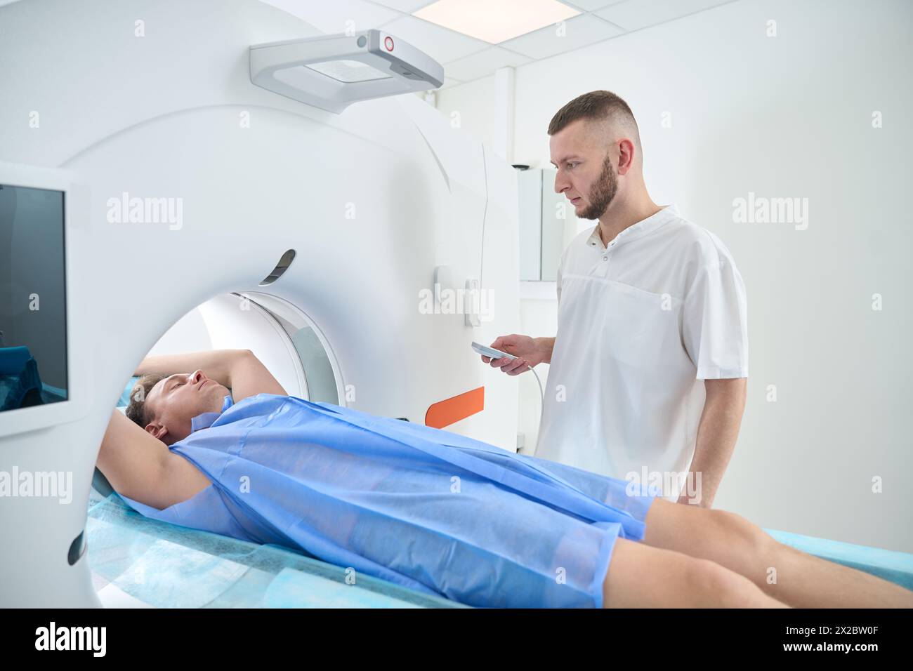 Healthcare professional is positioning patient for computed tomography ...