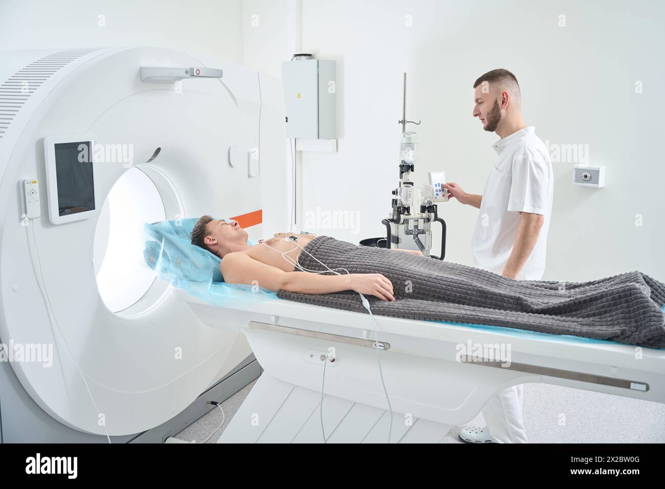 Man doing contrast-enhanced ECG-gated coronary computed tomography ...