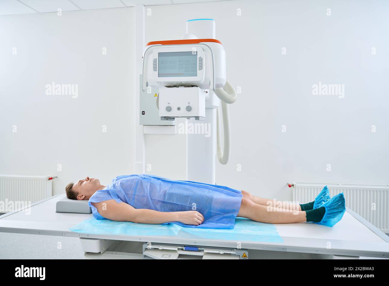 Adult patient prepared for digital radiography examination Stock Photo ...