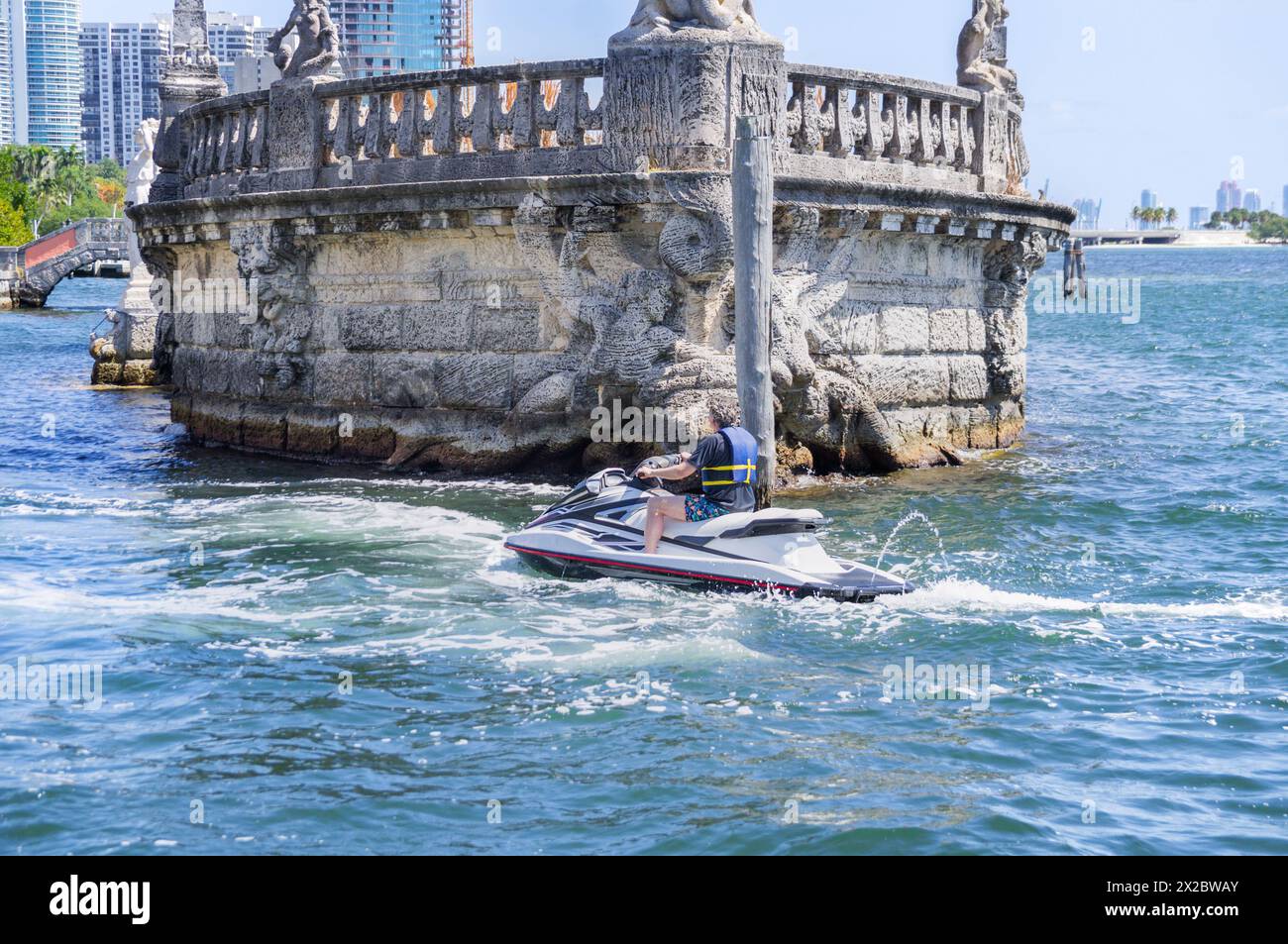 A tourist riding jet ski boats in turquoise waters of Biscayne Bay in ...