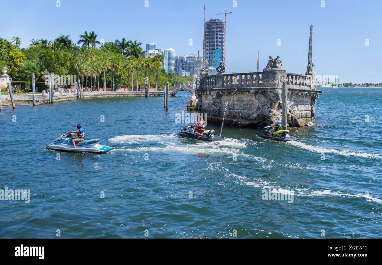 Tourists riding jet ski boats in turquoise waters of Biscayne Bay in ...