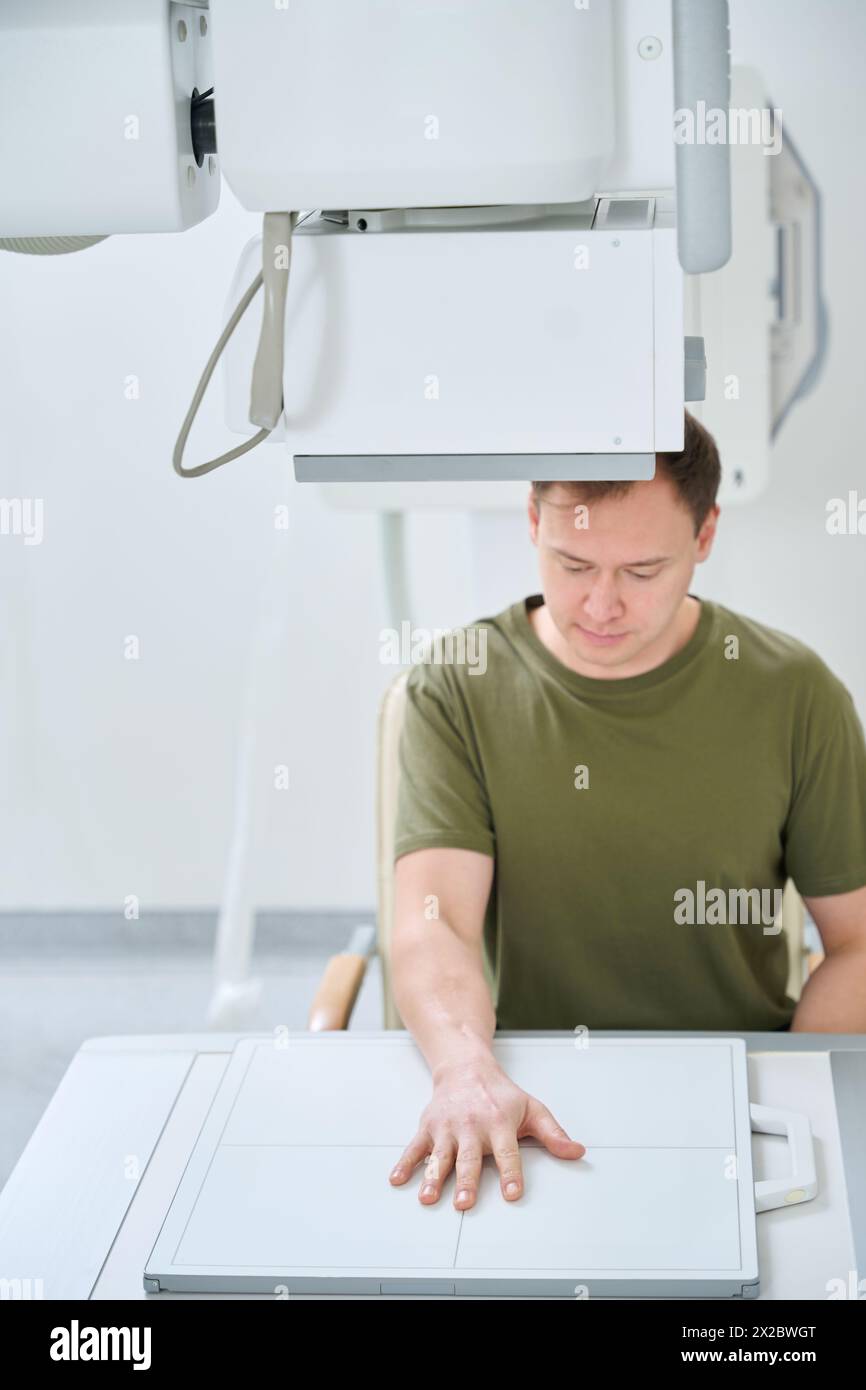 Adult man undergoing upper extremity x-ray examination Stock Photo - Alamy