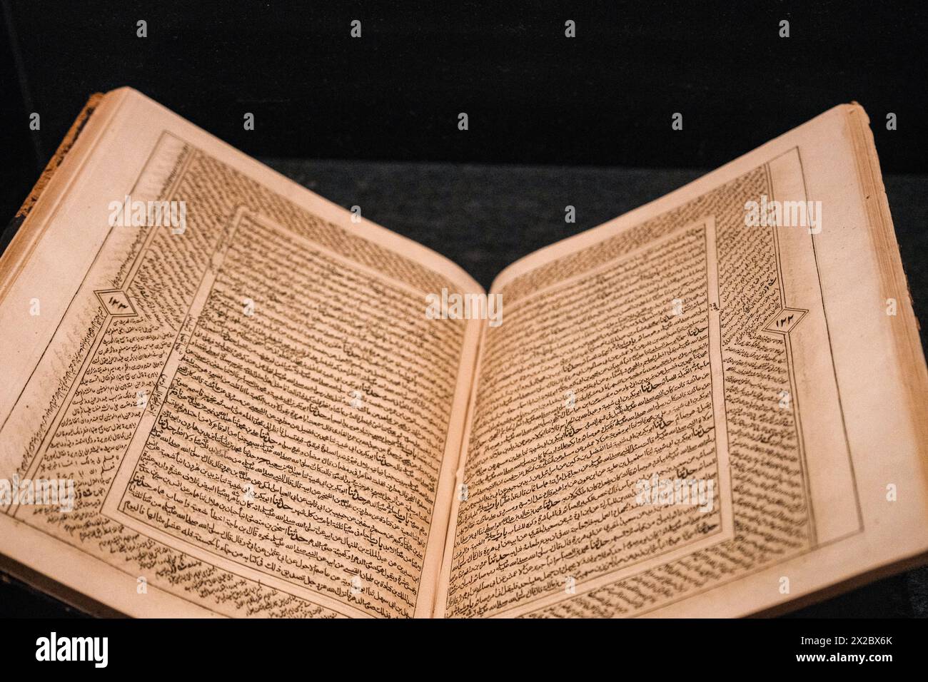 A detailed close-up of an ancient Quran, showcasing intricate ...