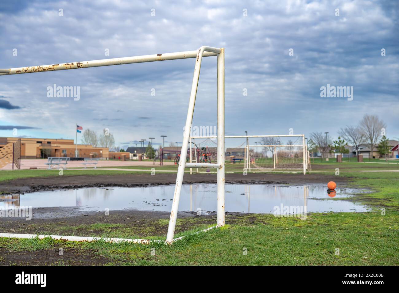 Soccer Goal in Field With Puddle of Water at a school Stock Photo - Alamy