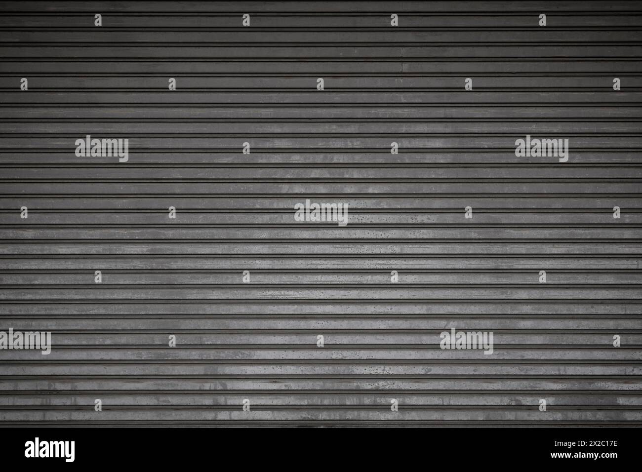 Front view of an old and weathered closed security roller door (or ...