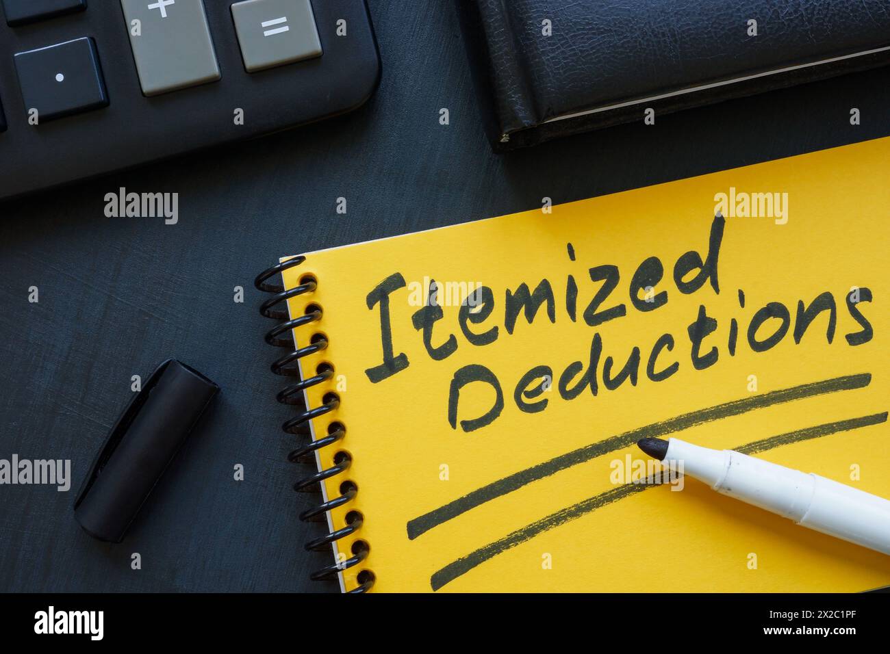 Itemized deductions handwritten note in a yellow notepad Stock Photo ...