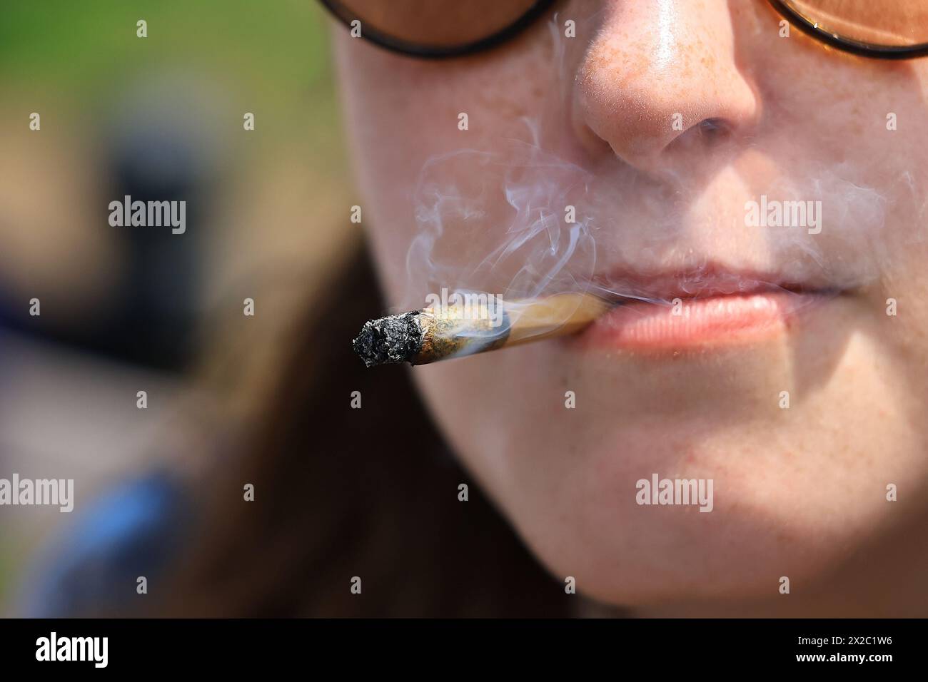 A young woman smokes weed at the 420 Festivities at Washington Square ...