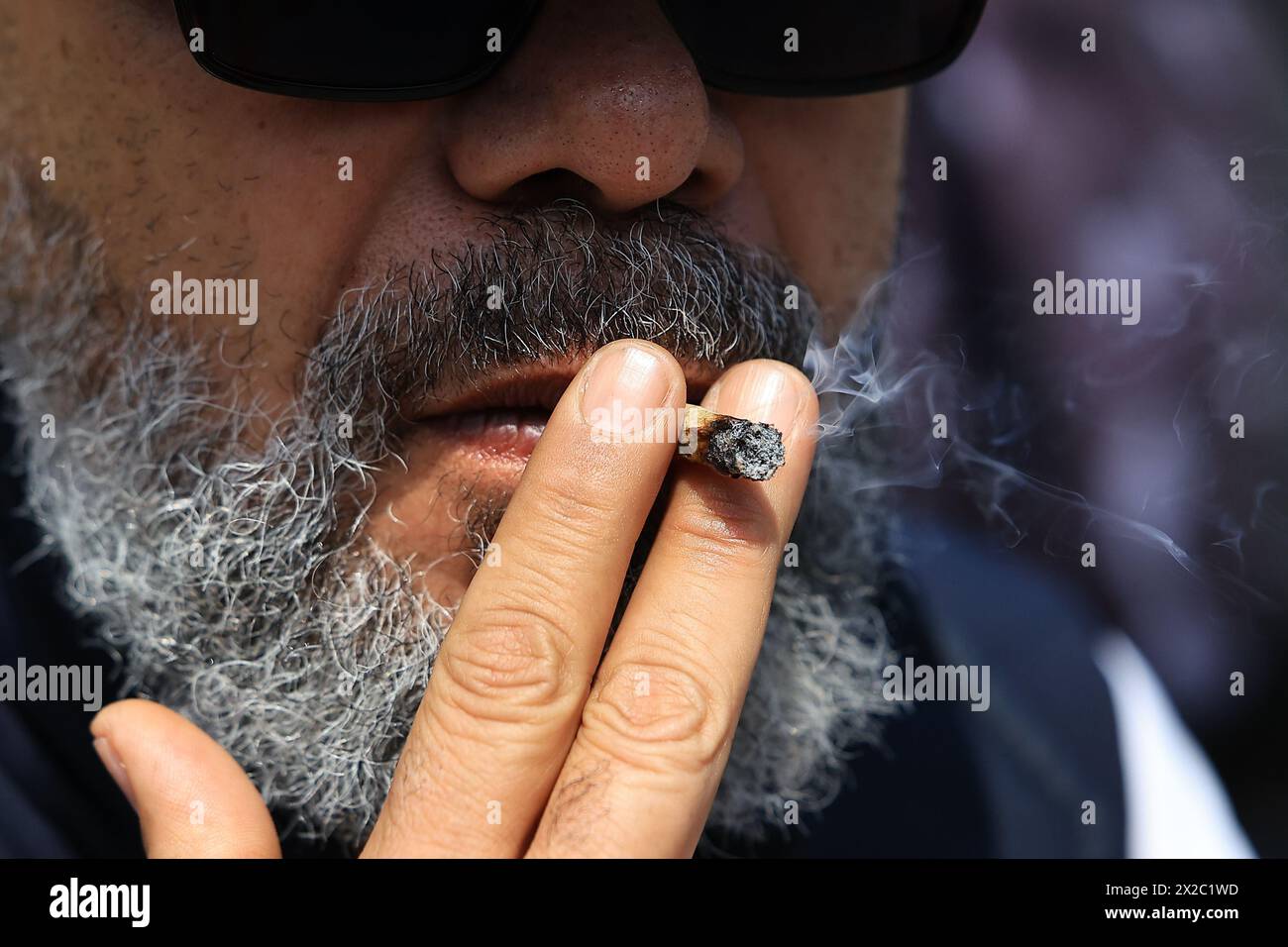 A man smokes marijuana at the 420 Festivities at Washington Square Park ...