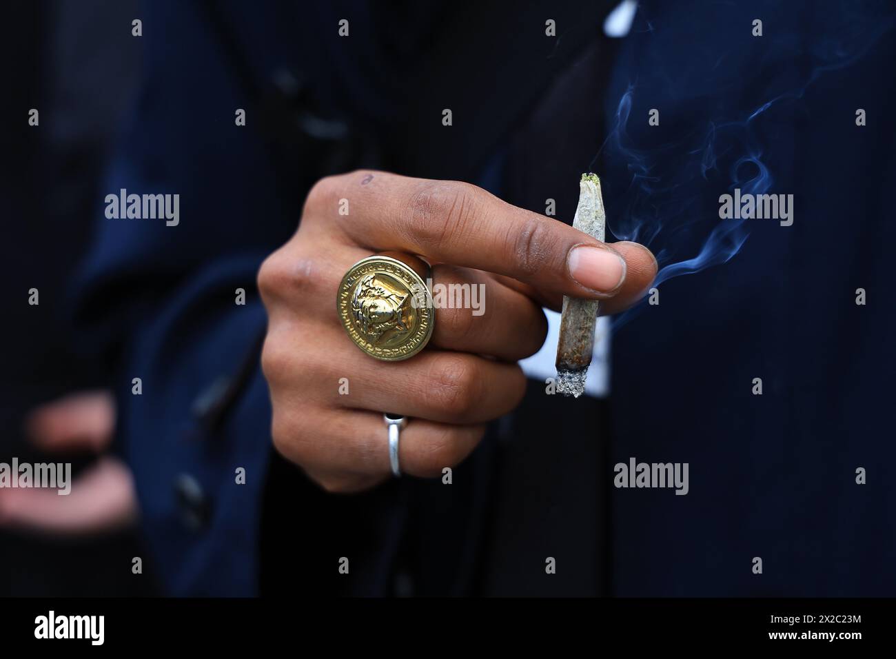 A man holds a marijuana cigarette at the 420 Festivities at Washington ...