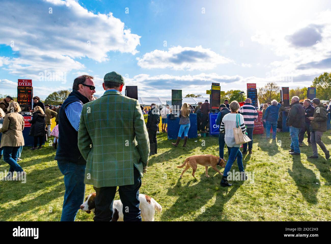 Crowds gather around the Bookmaker Stands in the field to place bets on ...