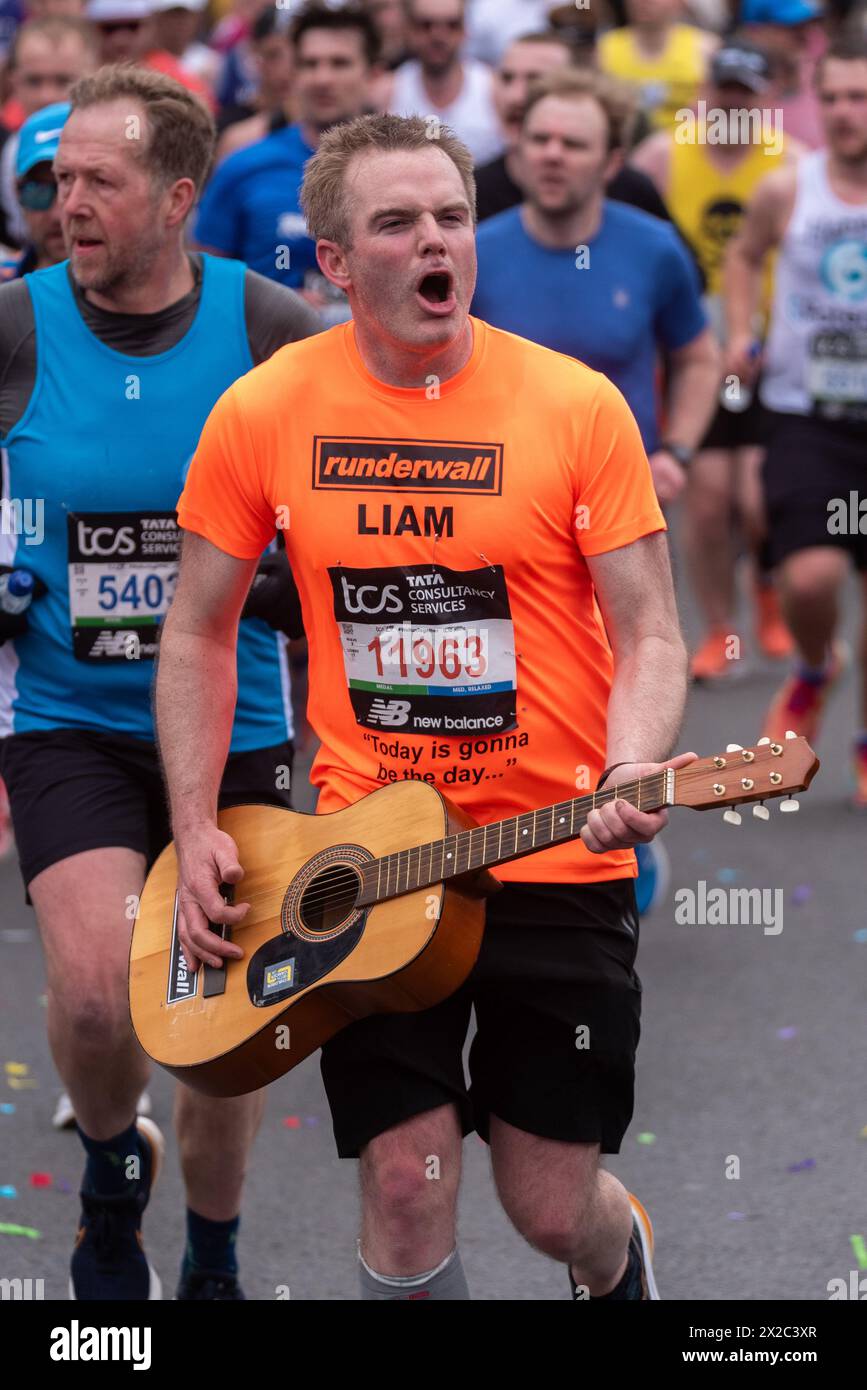 Runner Joe Birchley playing a guitar while competing in the TCS London ...
