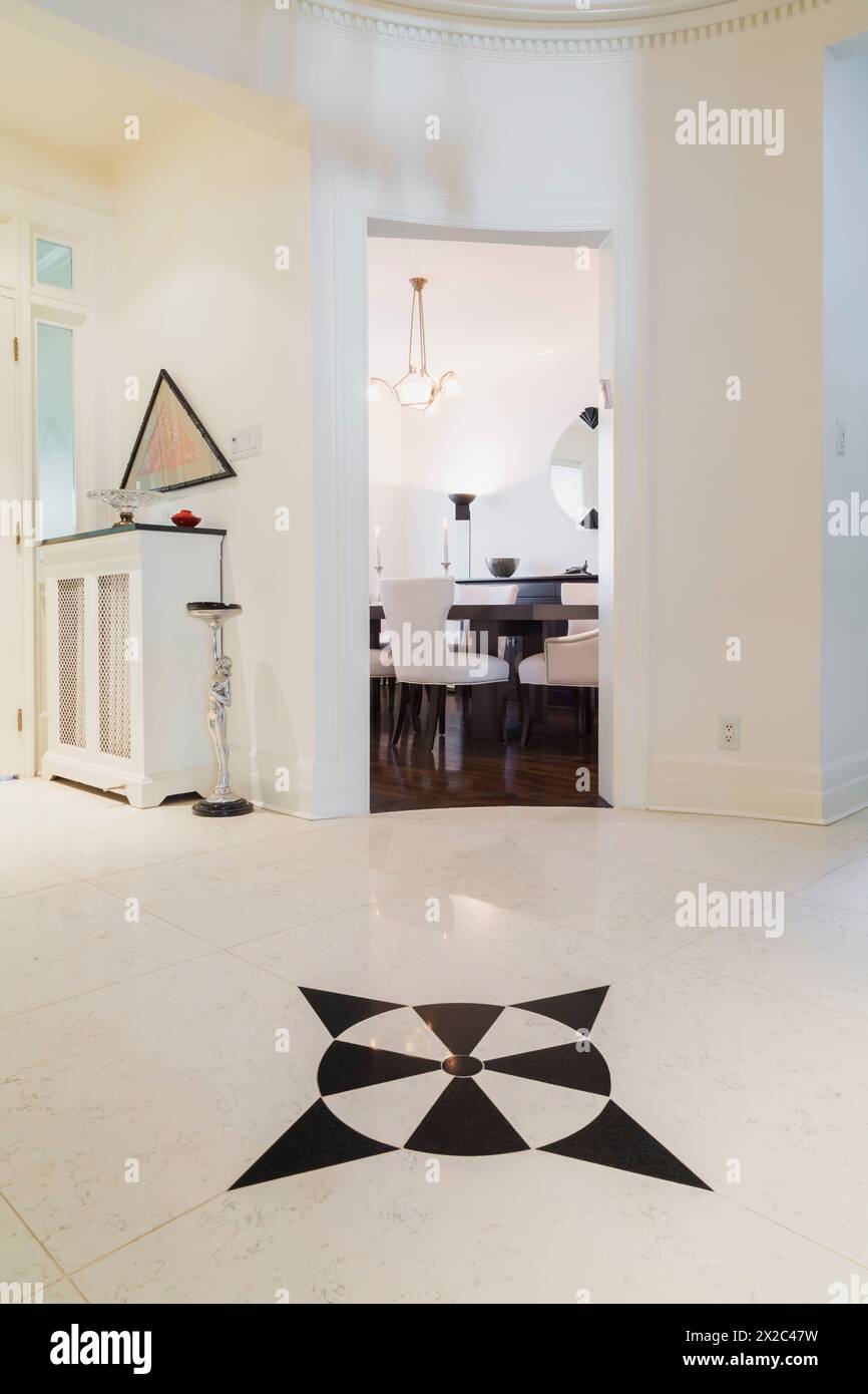 Circular entrance hallway with black arrow marks design inlaid in white ...