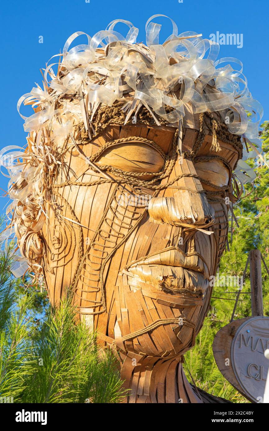 Representation of a large human head made from pieces of tree bark ...