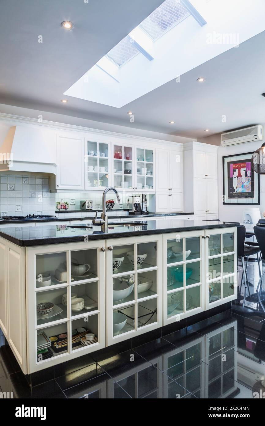 White wood and glass pane island with black granite countertop and ...