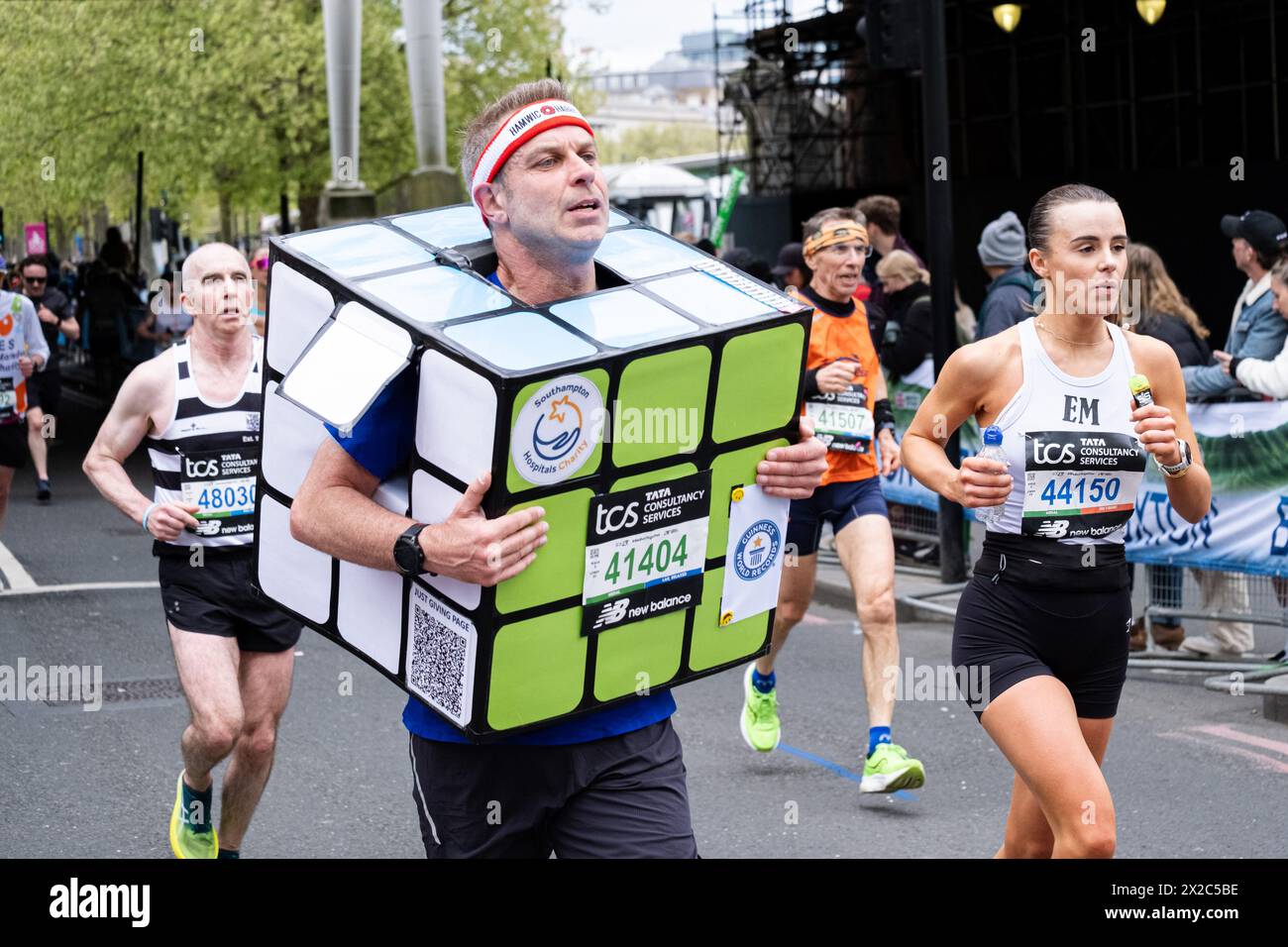 London, UK. 21st Apr, 2024. A runner in a Rubik's Cube costume takes ...