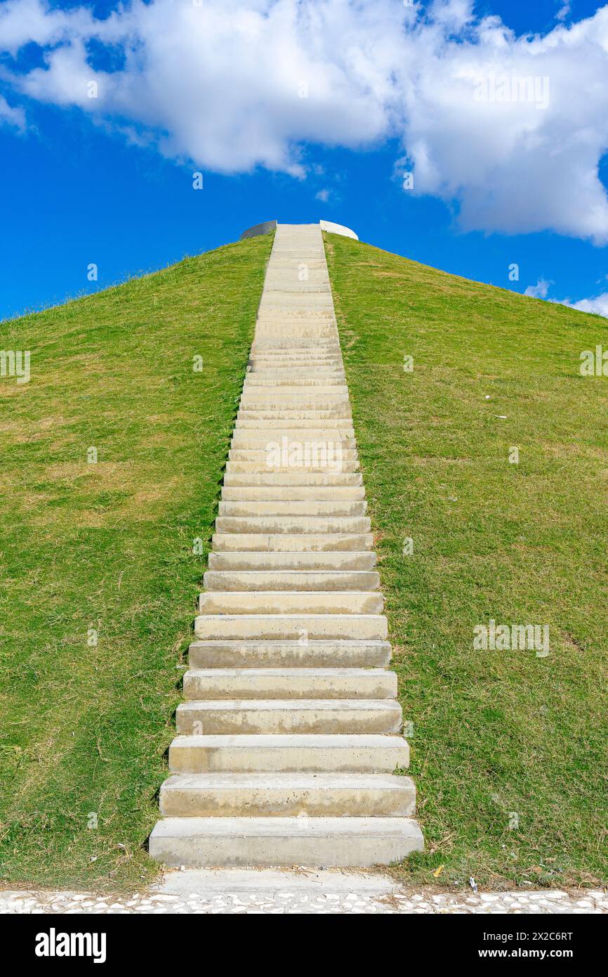 Volcanic cone-shaped grassy hill with grand staircase, city of Vlore ...