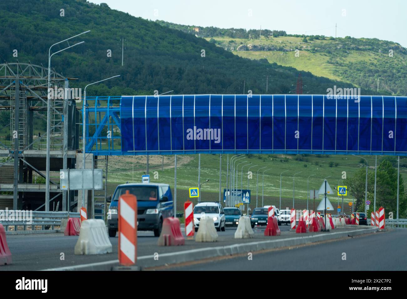 Red, white plastic safety barriers along road. Ensuring road safety ... Red, white plastic safety barriers along road. Ensuring road safety ...