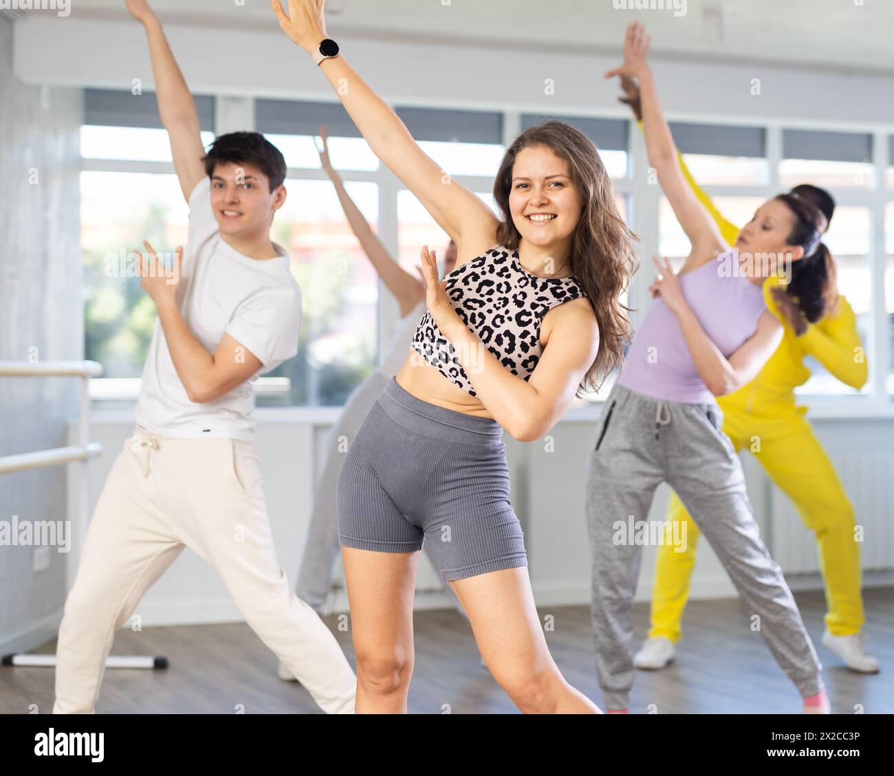 Young girl practicing hip-hop dance in training hall in group Stock ...